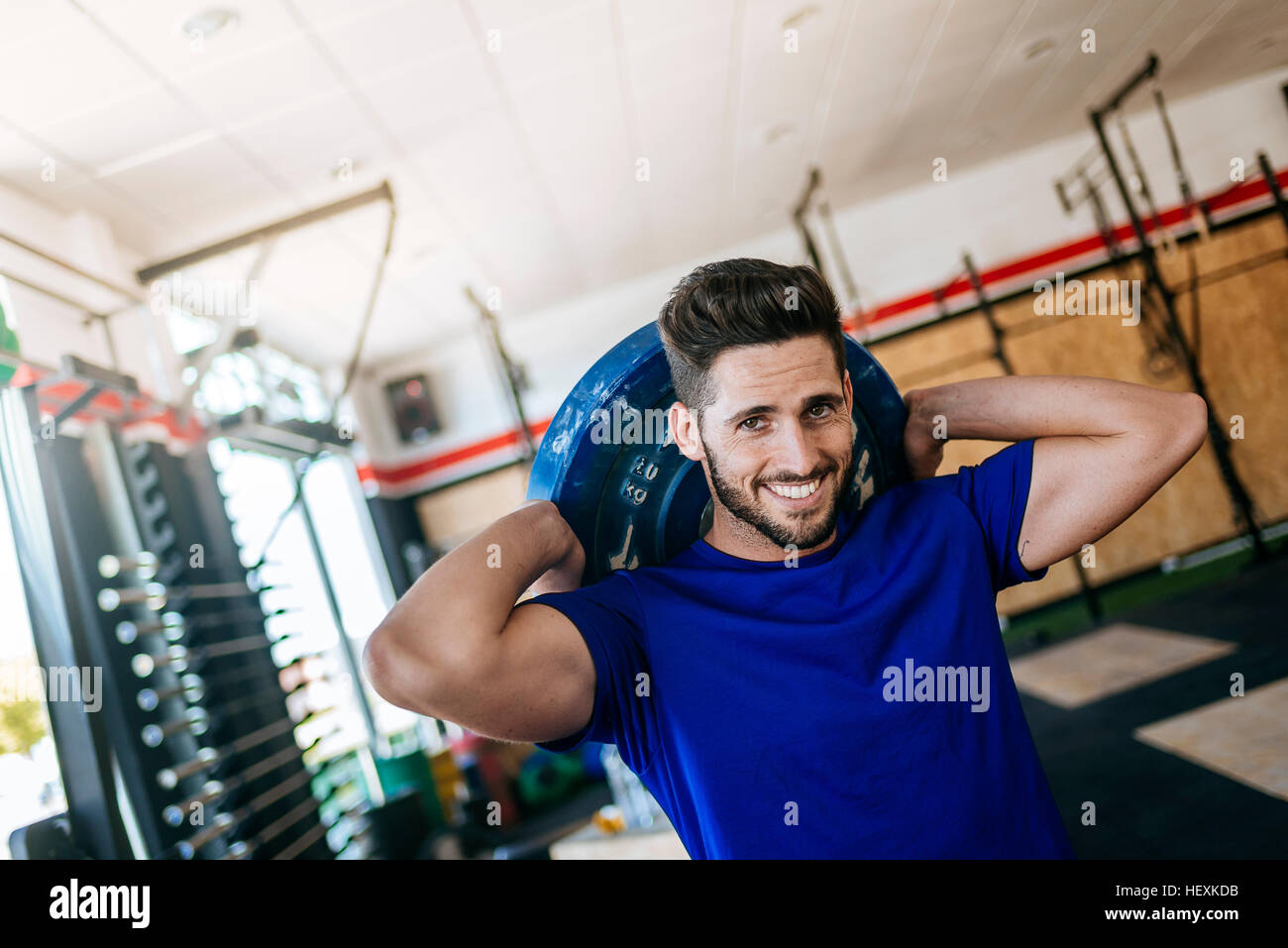 Portrait of smiling man with weight on his shoulders Stock Photo - Alamy