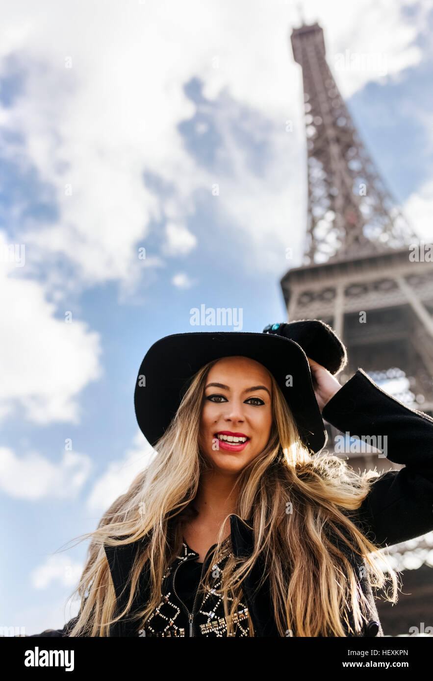 France, Paris, portrait of smiling woman in front of Eiffel Tower Stock ...