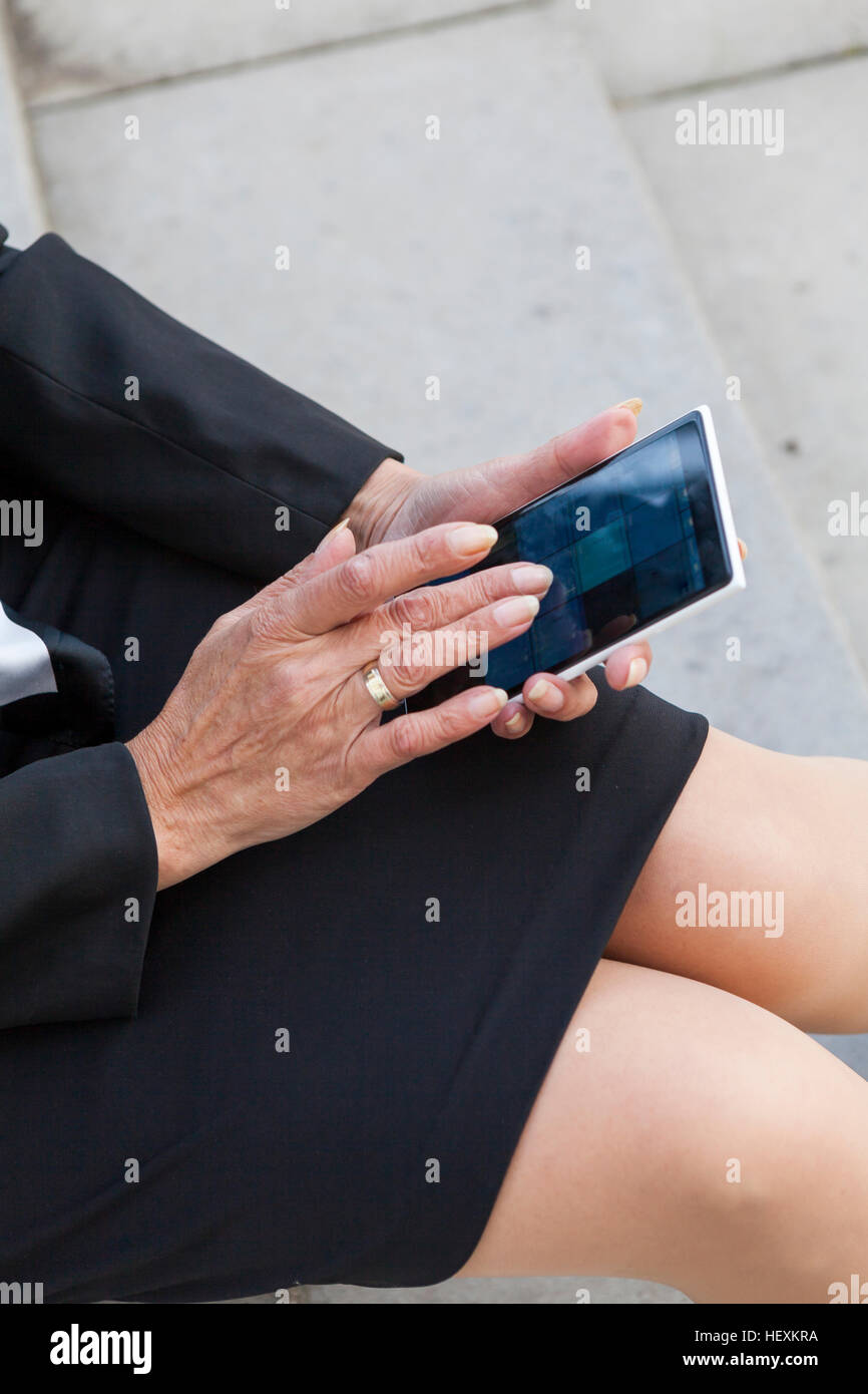 Woman's hand touching display of phablet Stock Photo - Alamy