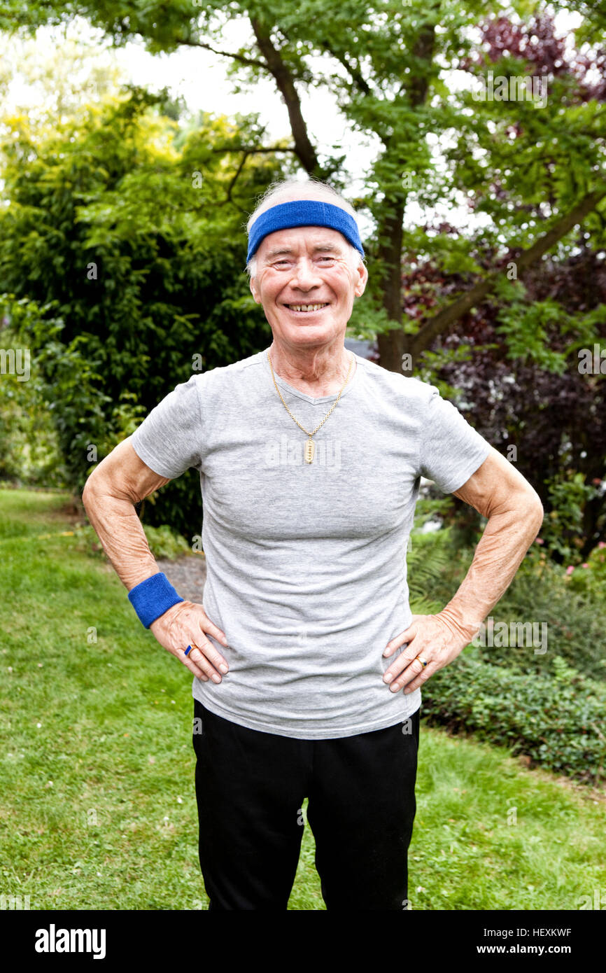 Senior man standing after fitness training in his garden Stock Photo ...