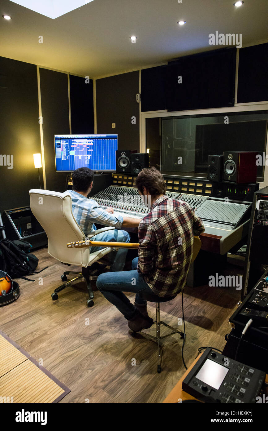 Guitar player and audio engineer in a recording studio Stock Photo - Alamy