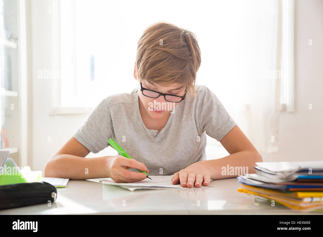 Boy doing homework Stock Photo - Alamy