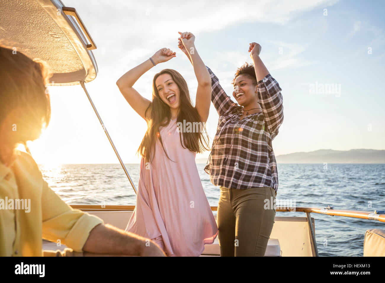 Happy friends having a party on a boat trip Stock Photo - Alamy