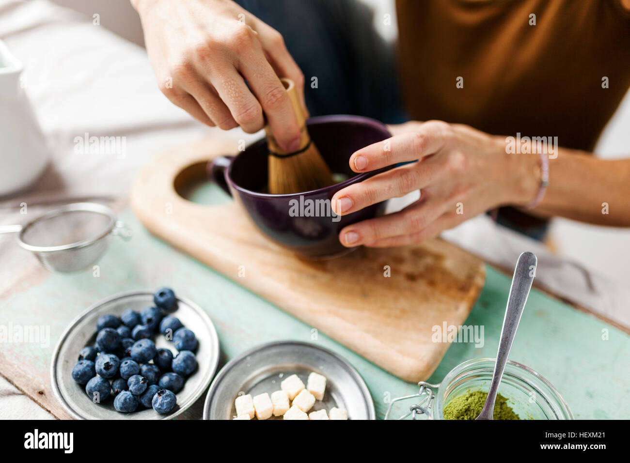 Woman preparing matcha latte at home Stock Photo - Alamy