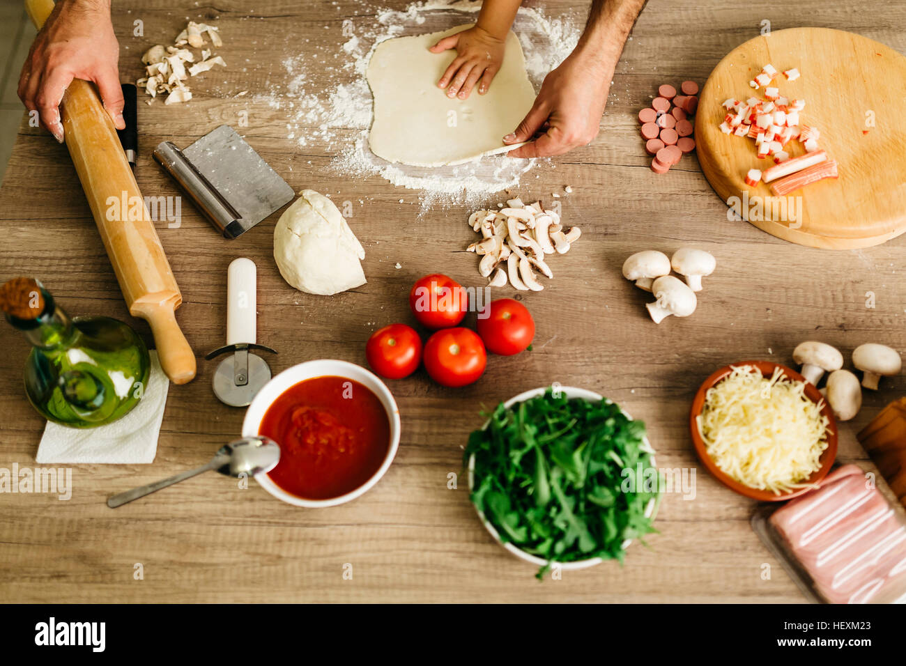 Father and son preparing pizza together Stock Photo - Alamy