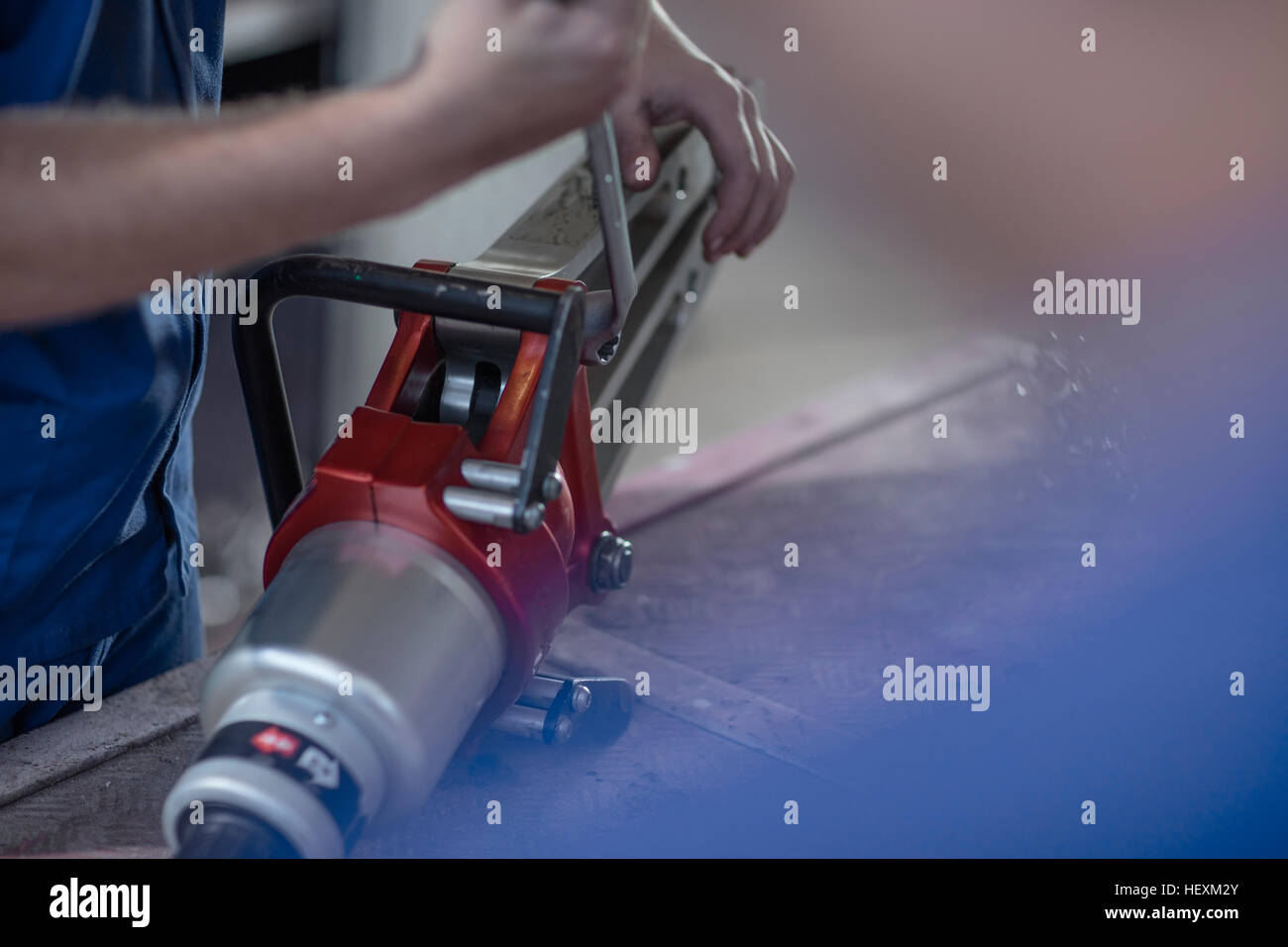 Mechanic working at fire brigade workshop, repairing claw Stock Photo ...