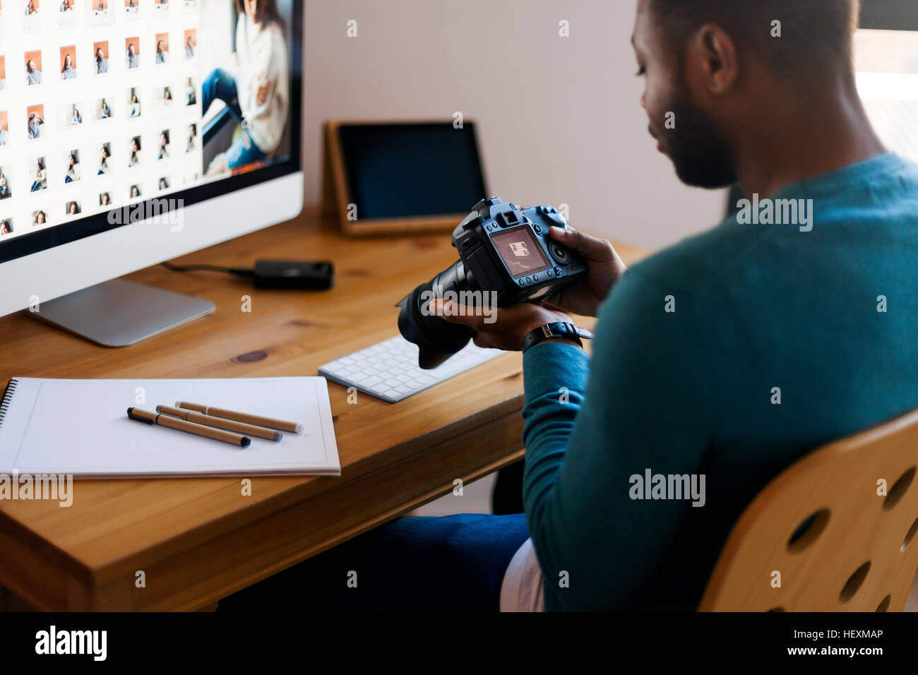 Young photographer editing images at desk Stock Photo - Alamy