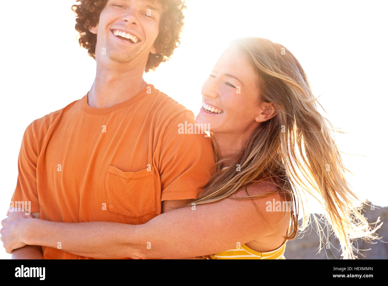 Happy couple hugging outdoors in summer Stock Photo - Alamy