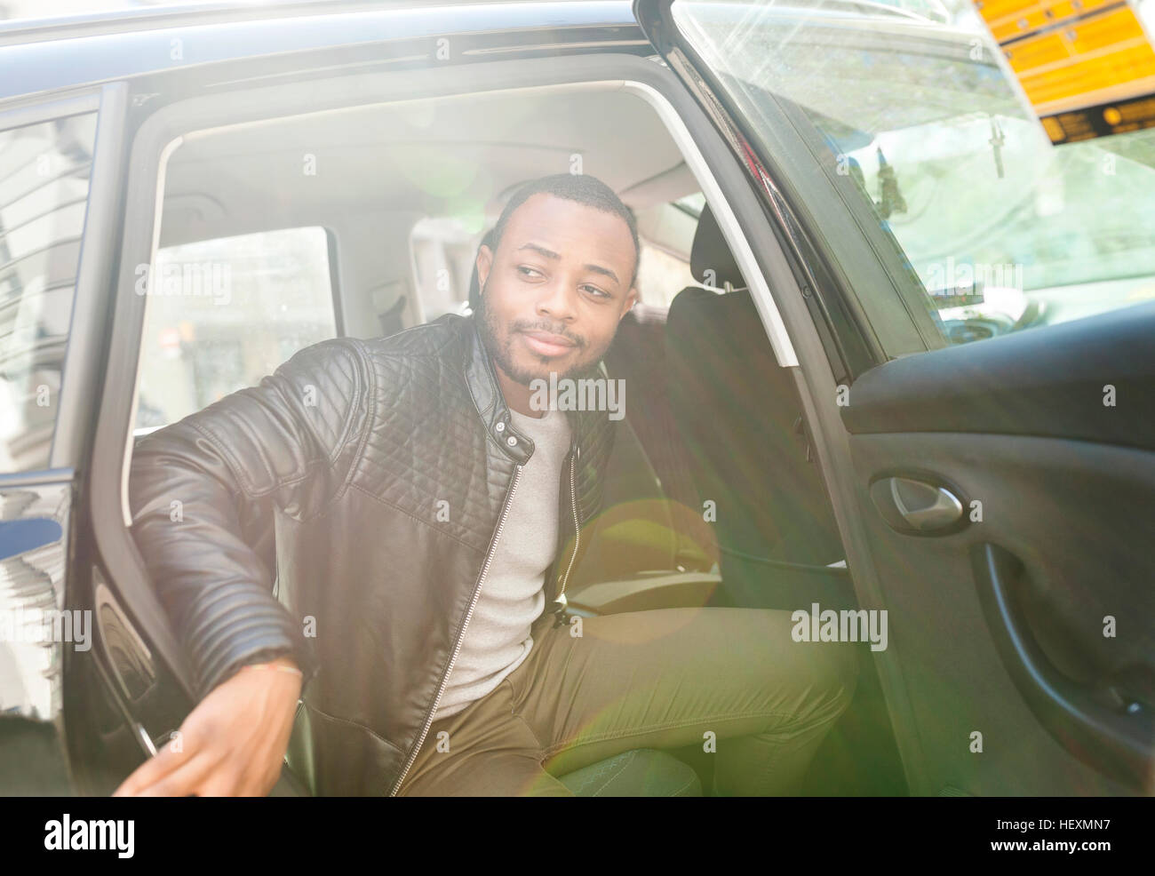 African man getting out car hi-res stock photography and images - Alamy