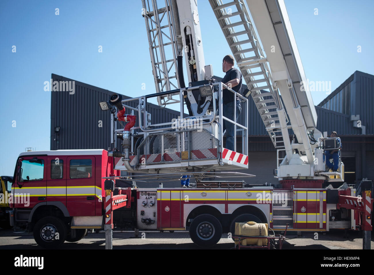 Mechanics maintaining fire engine Stock Photo - Alamy