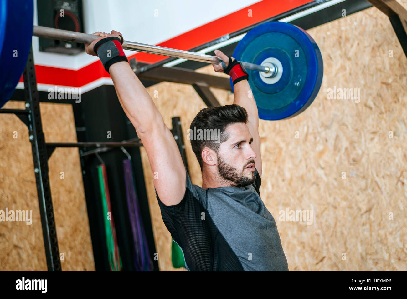 Man lifting barbell in gym Stock Photo - Alamy