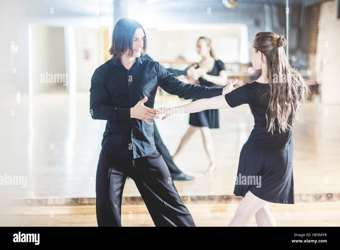 Couple dancing tango in studio Stock Photo - Alamy