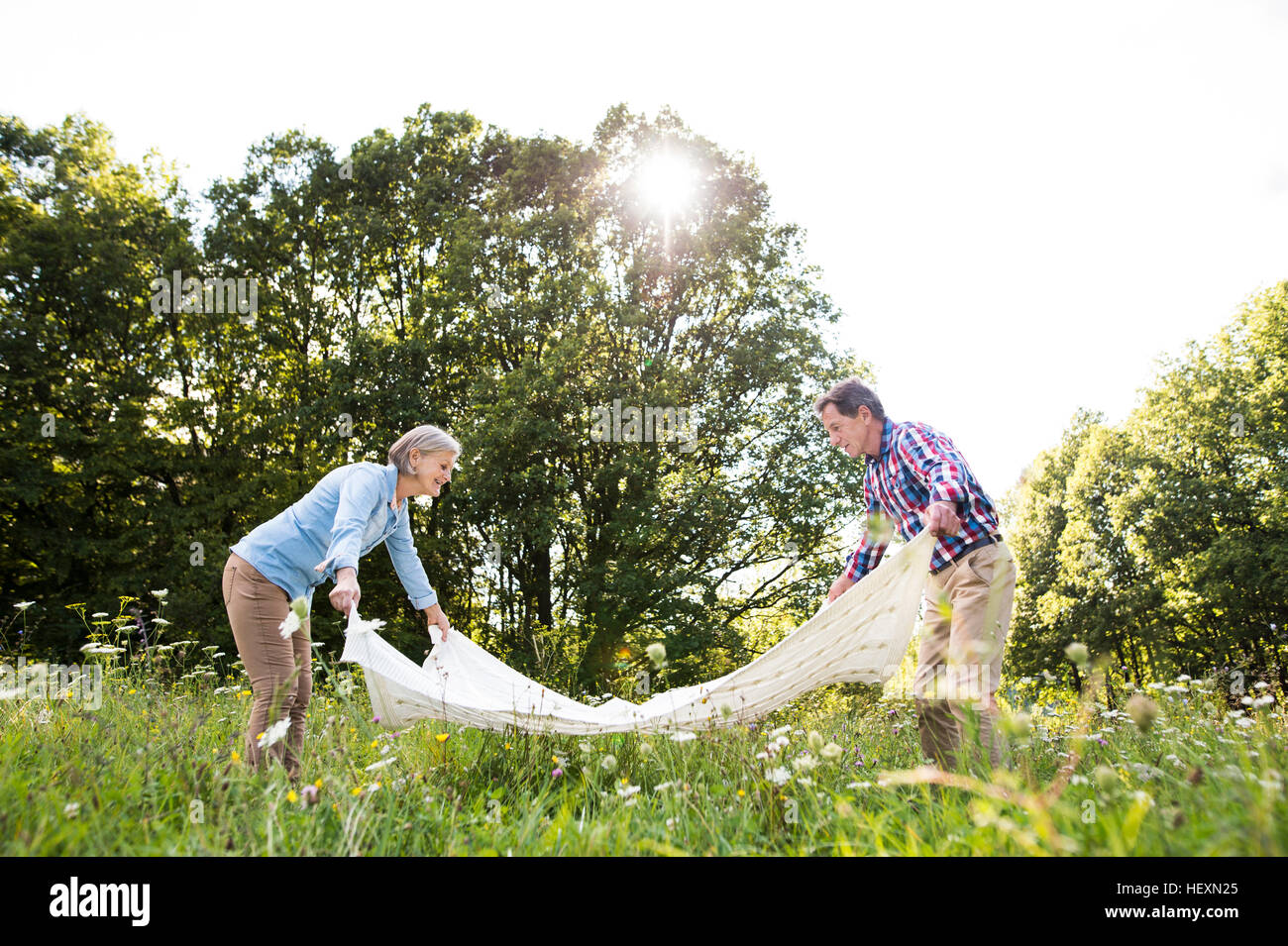 Spreading a blanket hi-res stock photography and images - Alamy