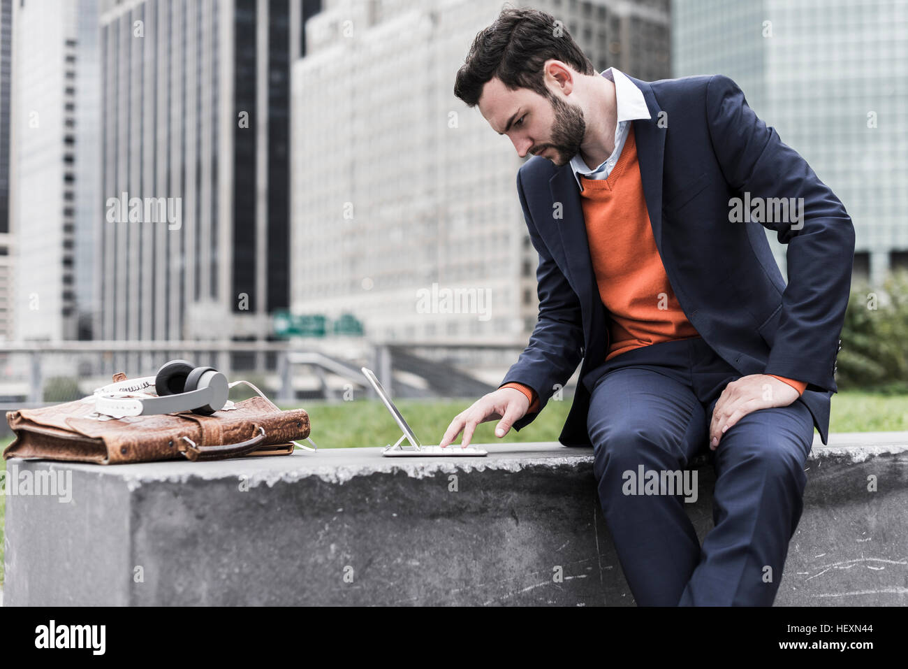 USA, New York City, Businessman working outdoor sitting on bench Stock ...