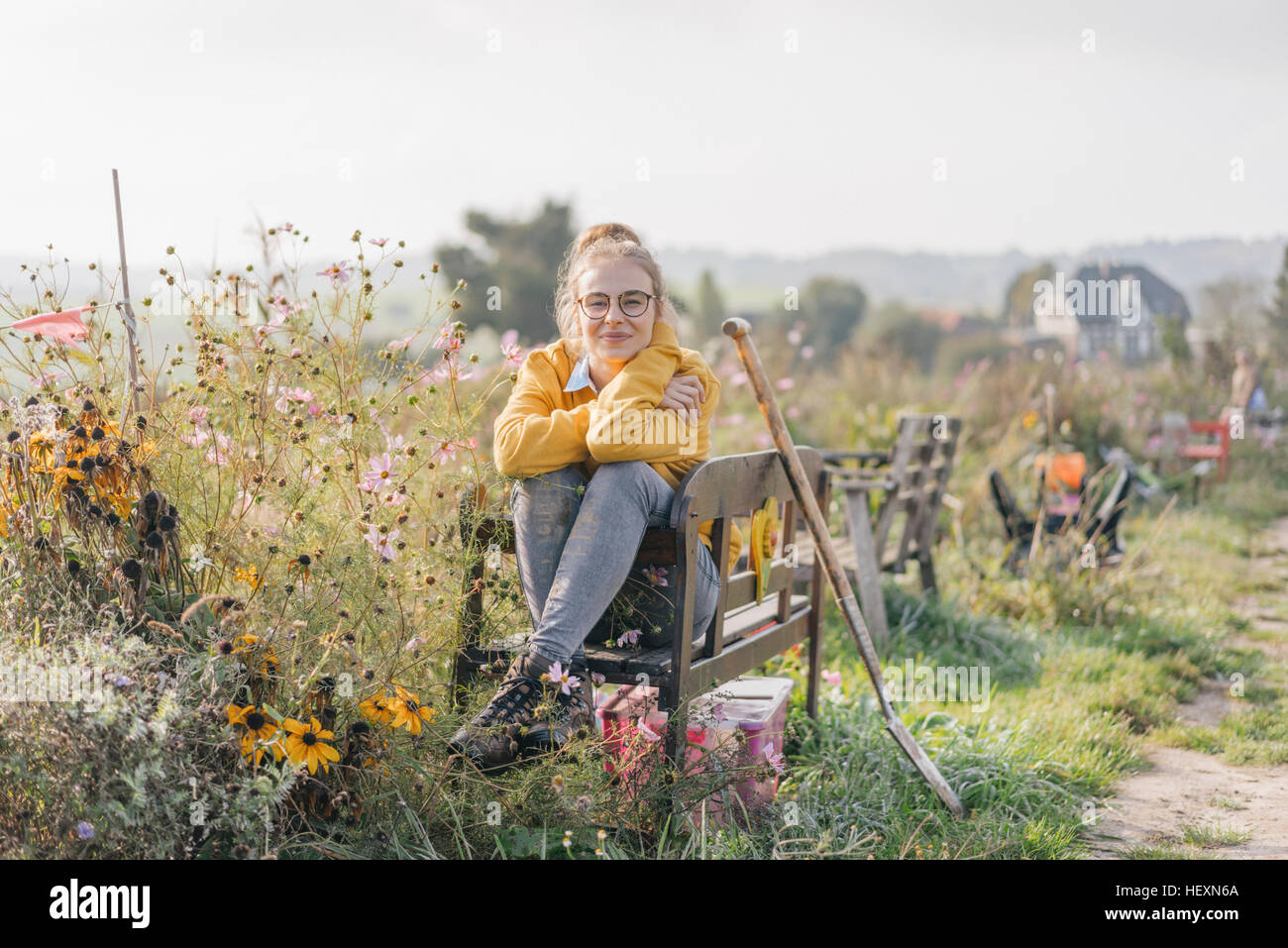 Young woman relaxing in cottage garden Stock Photo - Alamy