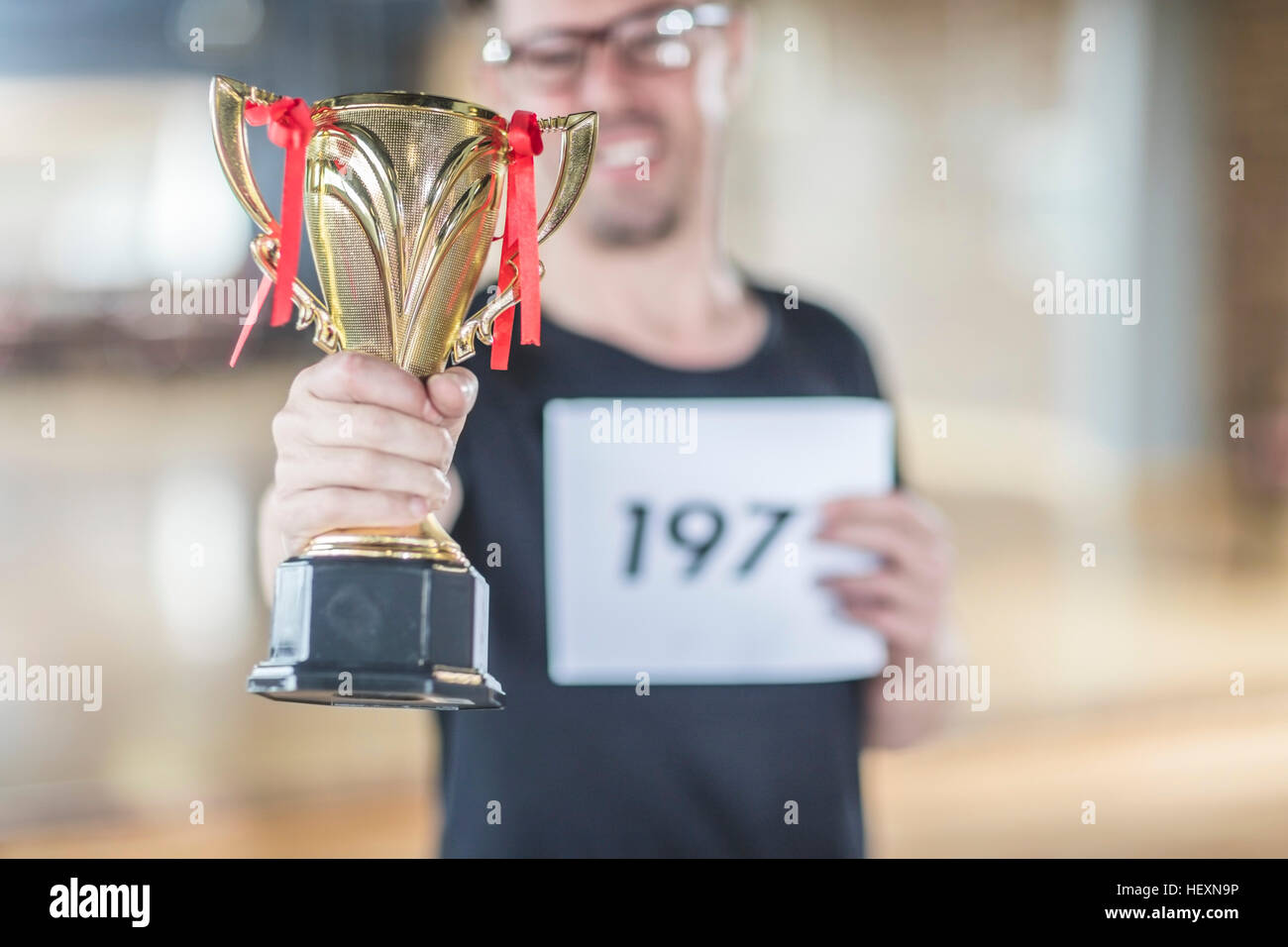 Male dance winner holding trophy Stock Photo - Alamy