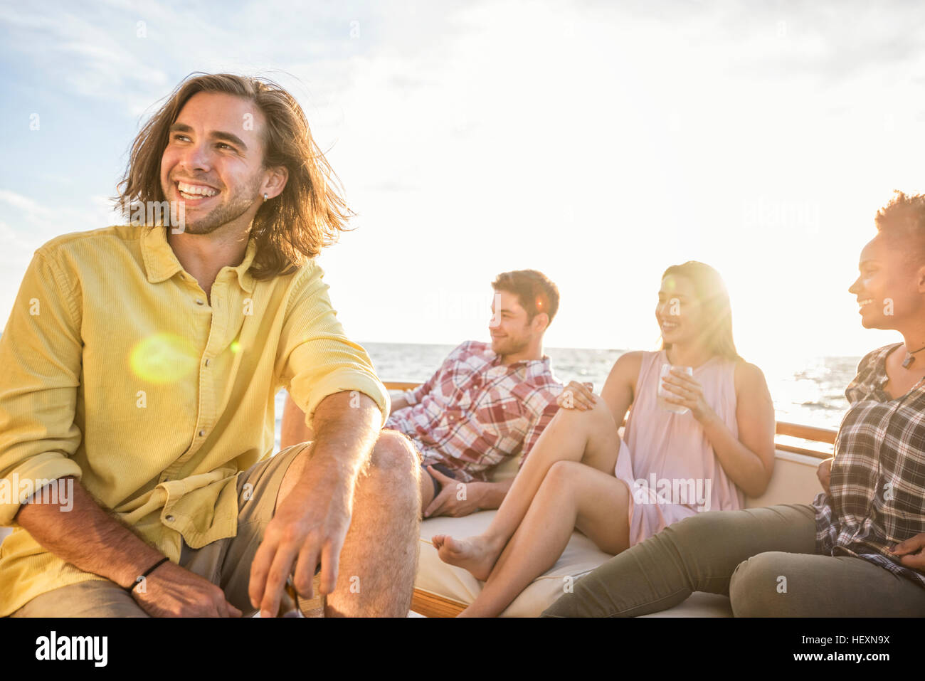 Happy friends hanging out on a boat trip Stock Photo - Alamy
