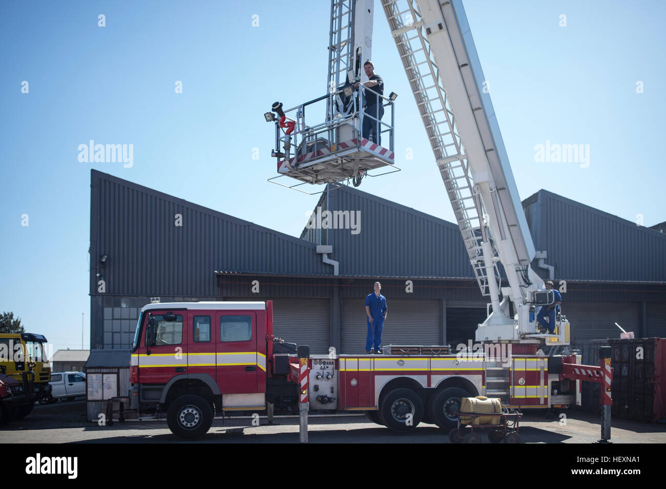 Mechanics maintaining fire engine Stock Photo - Alamy