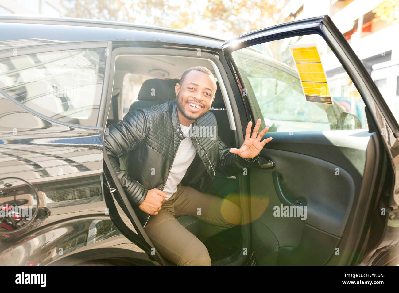 African man getting out car hi-res stock photography and images - Alamy