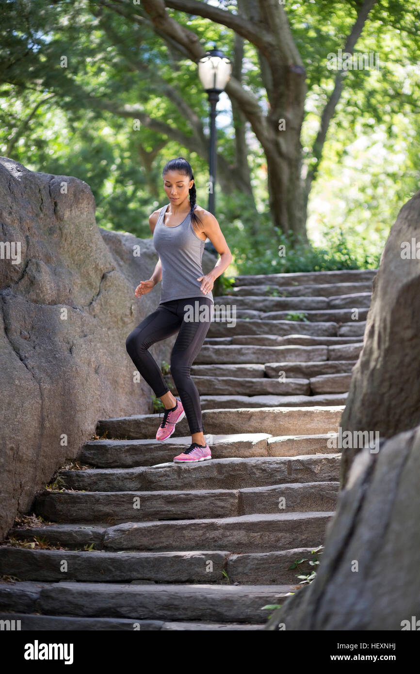 Woman running down stairs Stock Photo - Alamy