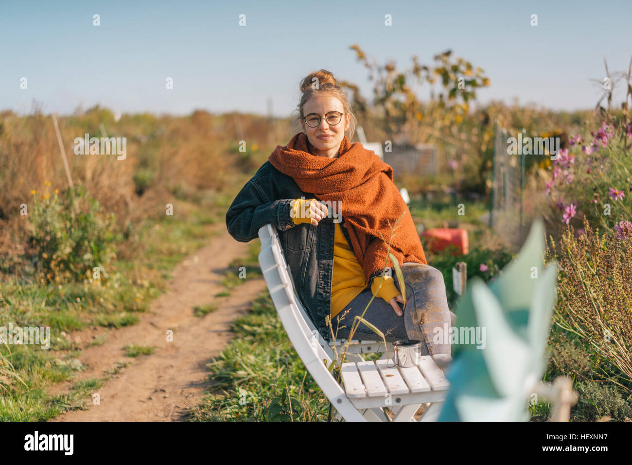 Young woman relaxing in cottage garden Stock Photo - Alamy