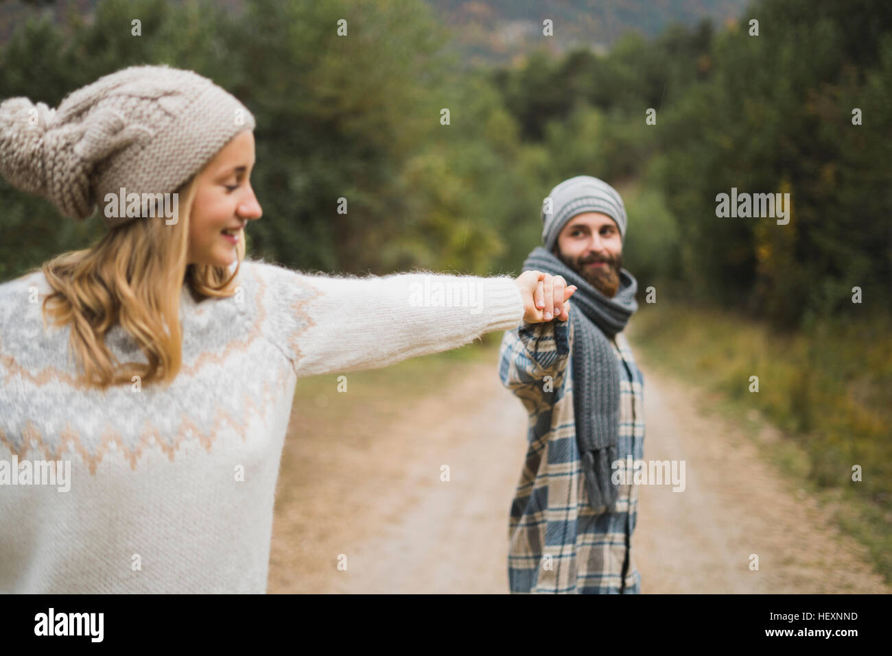 Young couple hand in hand on path in autumn Stock Photo - Alamy