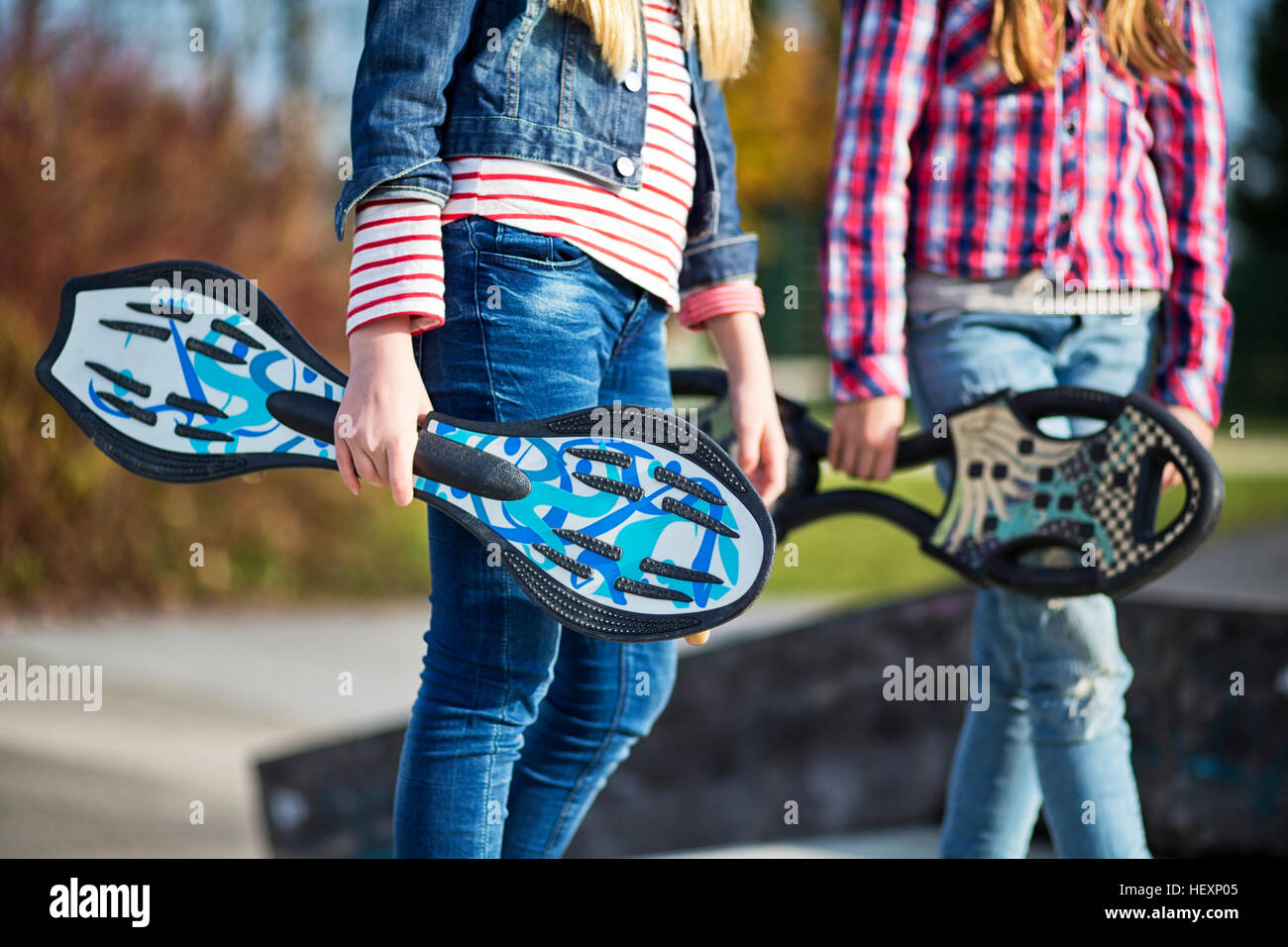 Two girls with skateboards, partial view Stock Photo - Alamy