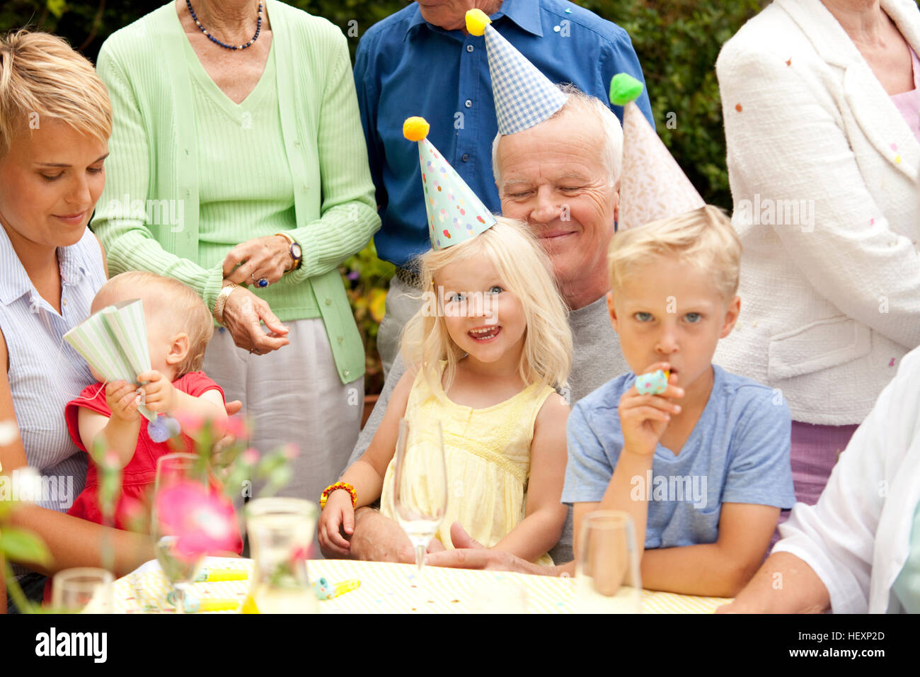 Extended family and friends having birthday party in garden Stock Photo ...