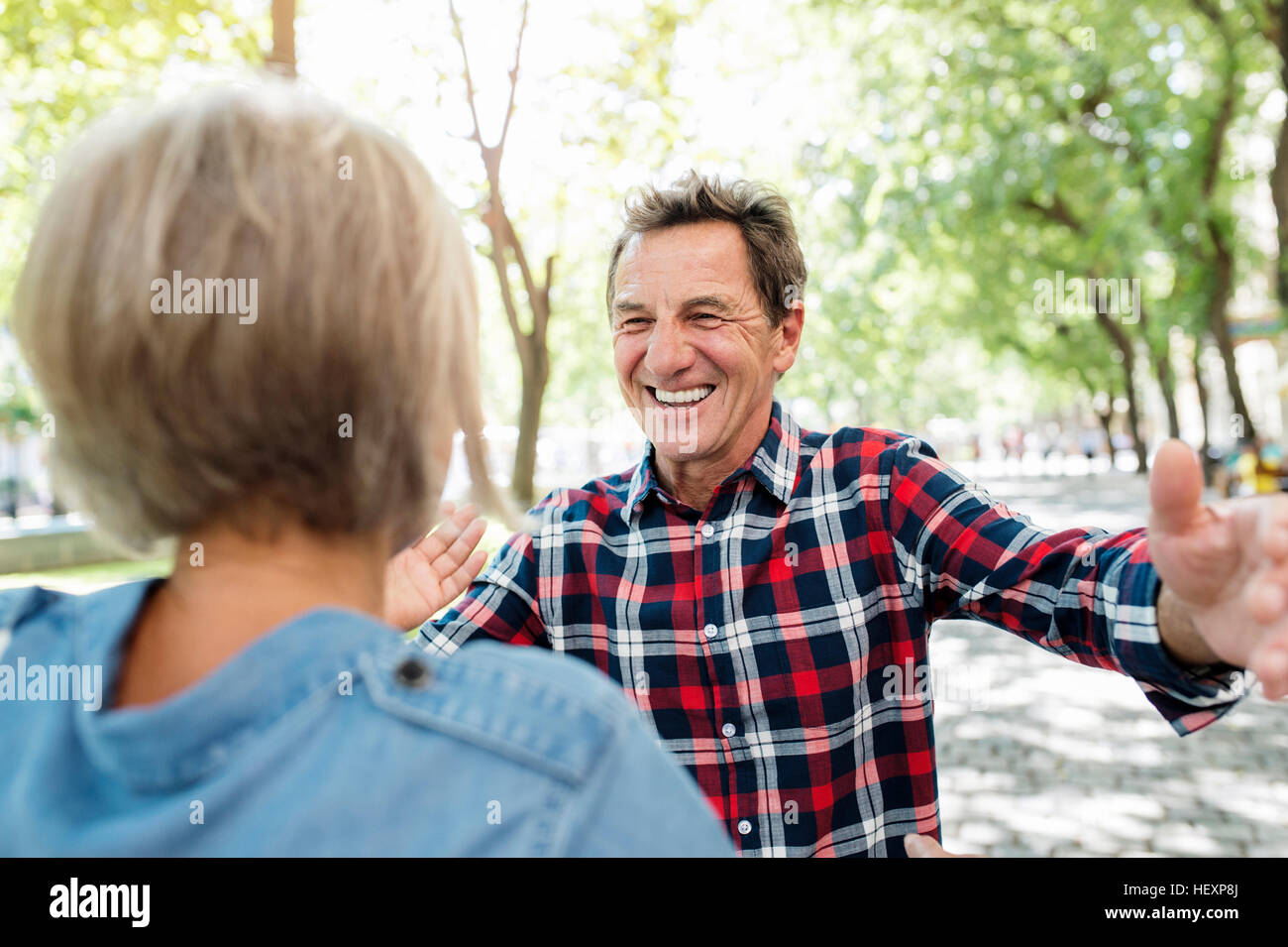 Portrait of happy senior man greeting senior woman Stock Photo - Alamy