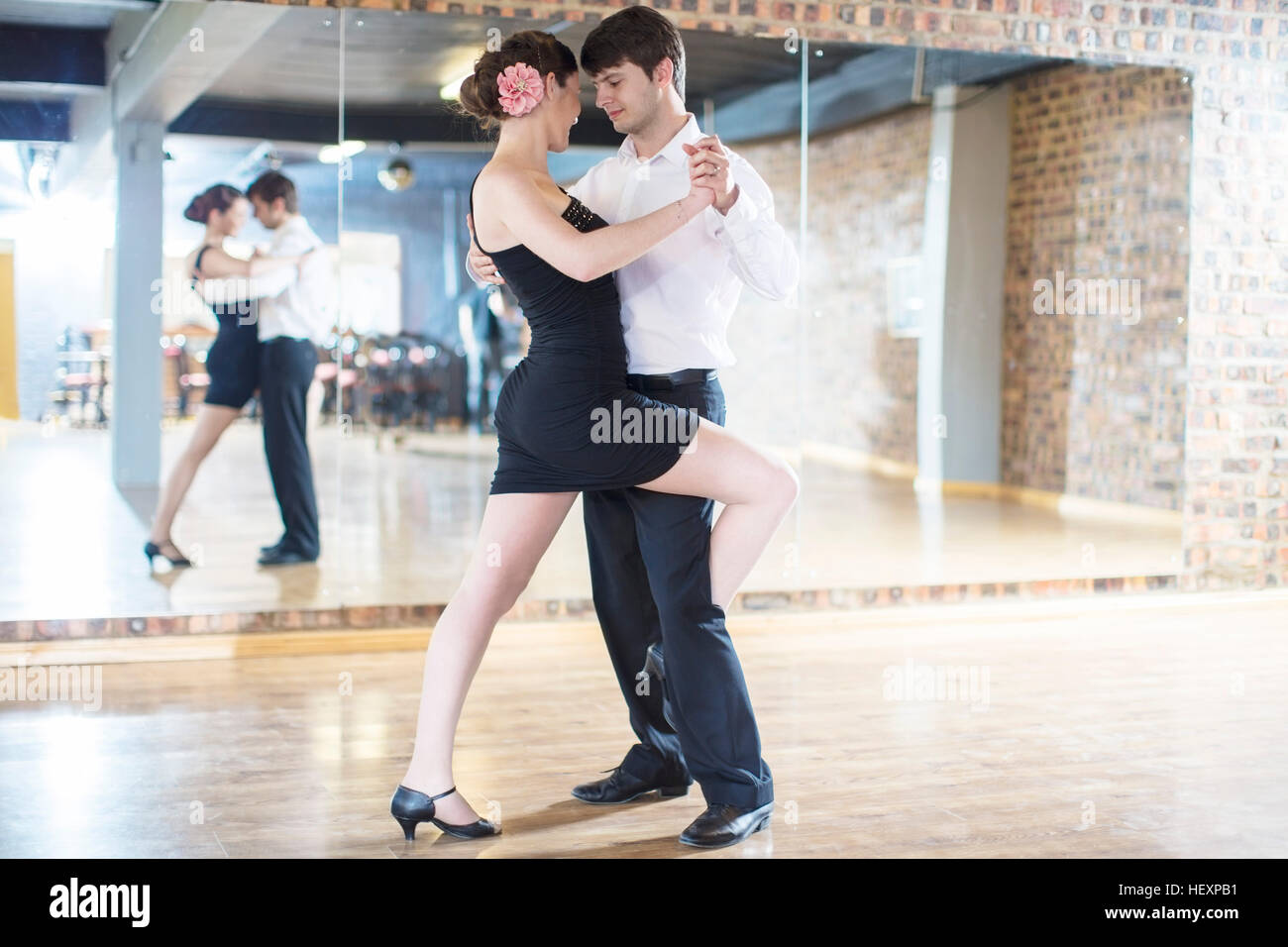 Couple dancing salsa in studio Stock Photo - Alamy