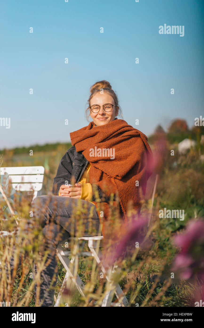 Young woman relaxing in cottage garden Stock Photo - Alamy