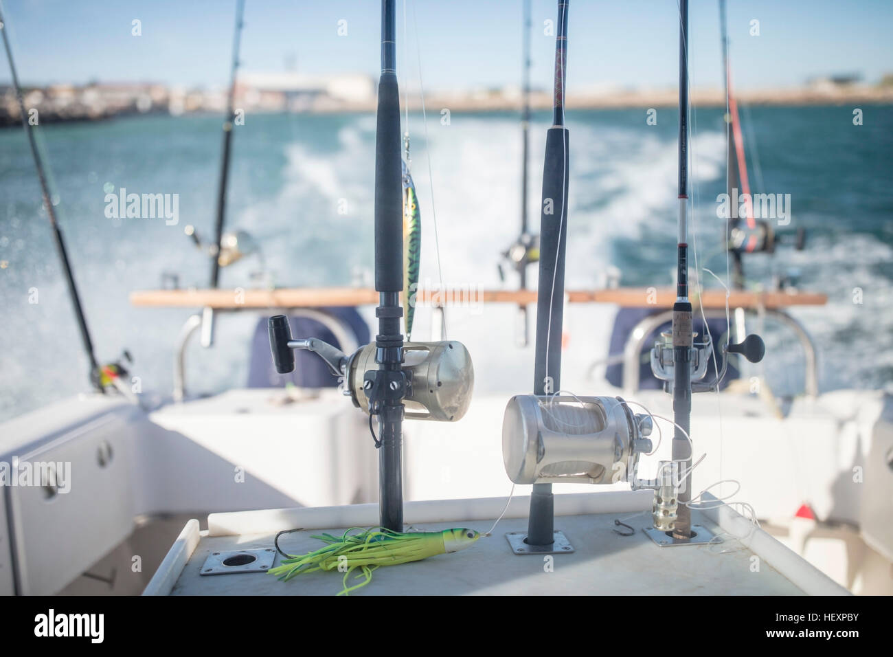 Fishing rods on moving boat Stock Photo - Alamy