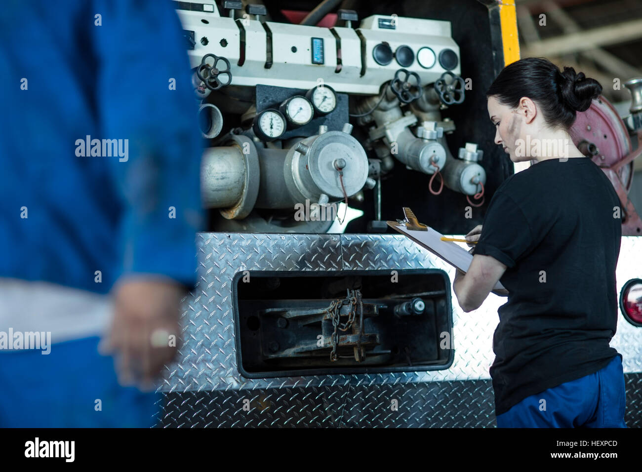 Mechanics working at fire brigade workshop hi-res stock photography and ...