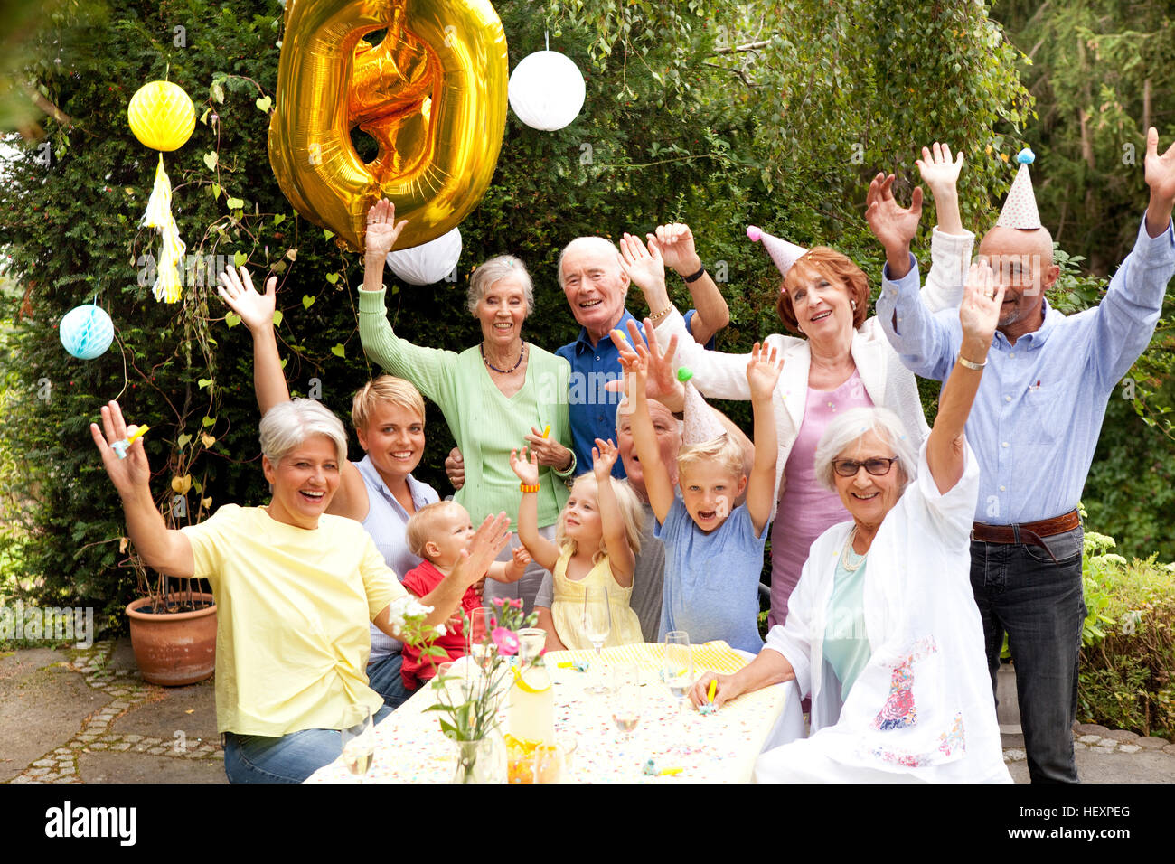 Extended family and friends having birthday party in garden Stock Photo ...