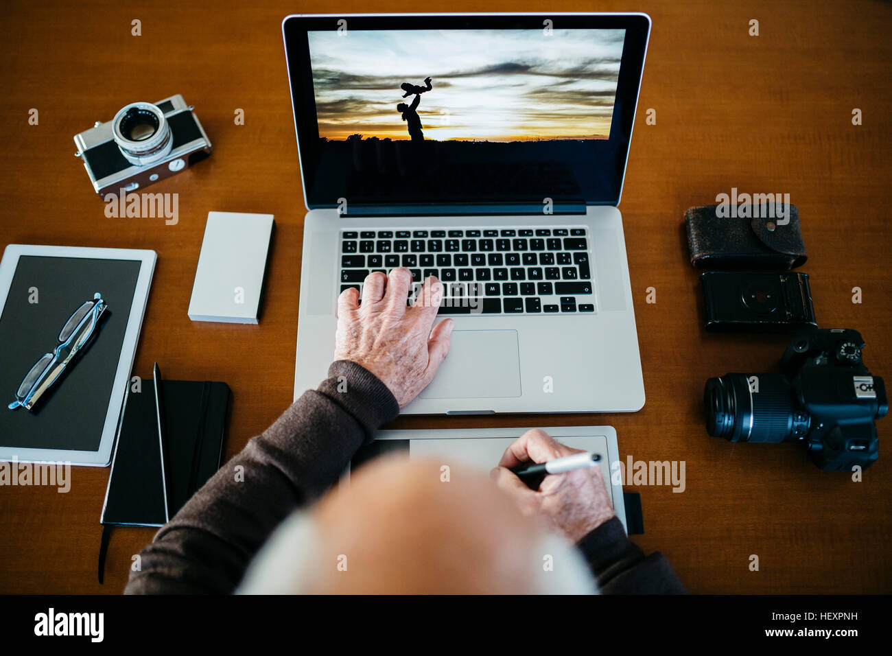 Senior photographer working with laptop, top view Stock Photo - Alamy
