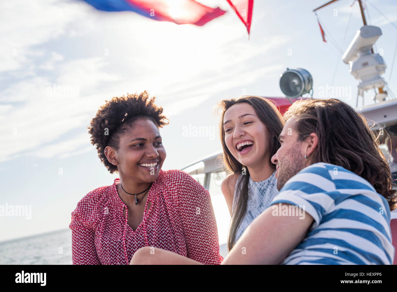 Happy friends on a boat trip Stock Photo - Alamy