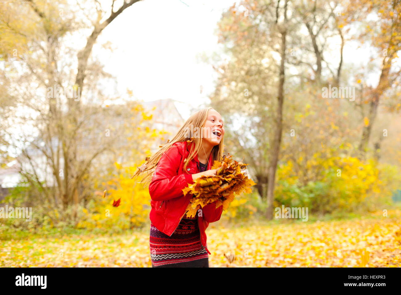 Laughing girl with autumn leaves Stock Photo - Alamy