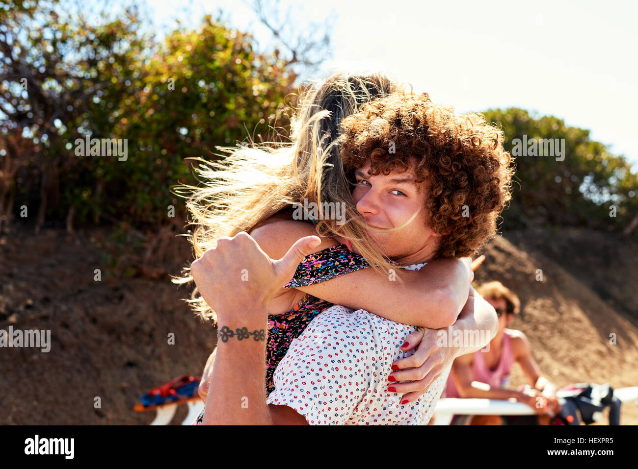 Happy couple hugging outdoors in summer Stock Photo - Alamy