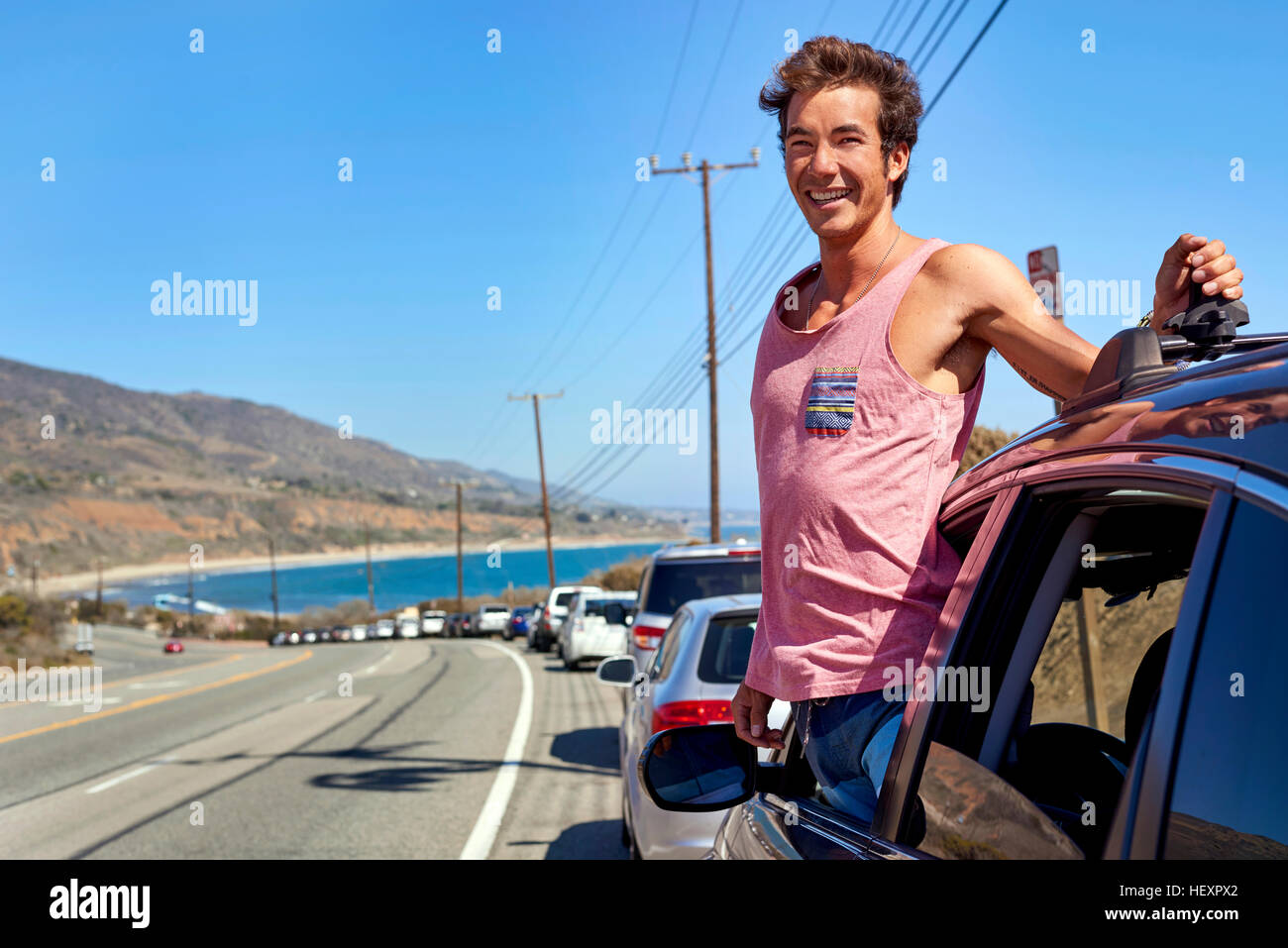 Happy young man on a road trip in summer Stock Photo - Alamy