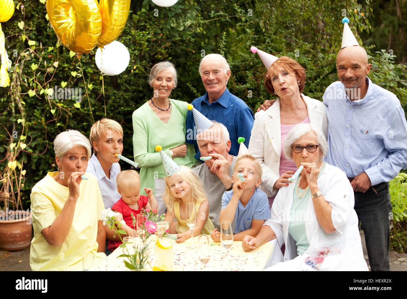 Extended family and friends having birthday party in garden Stock Photo ...
