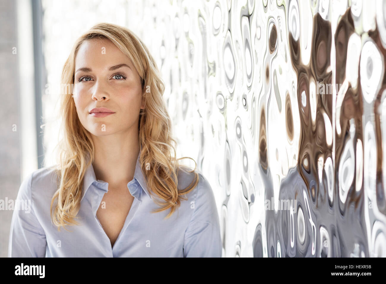 Portrait of confident businesswoman at rippled wall Stock Photo - Alamy