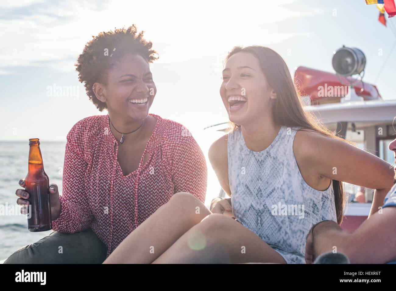 Happy friends on a boat trip having a beer Stock Photo - Alamy