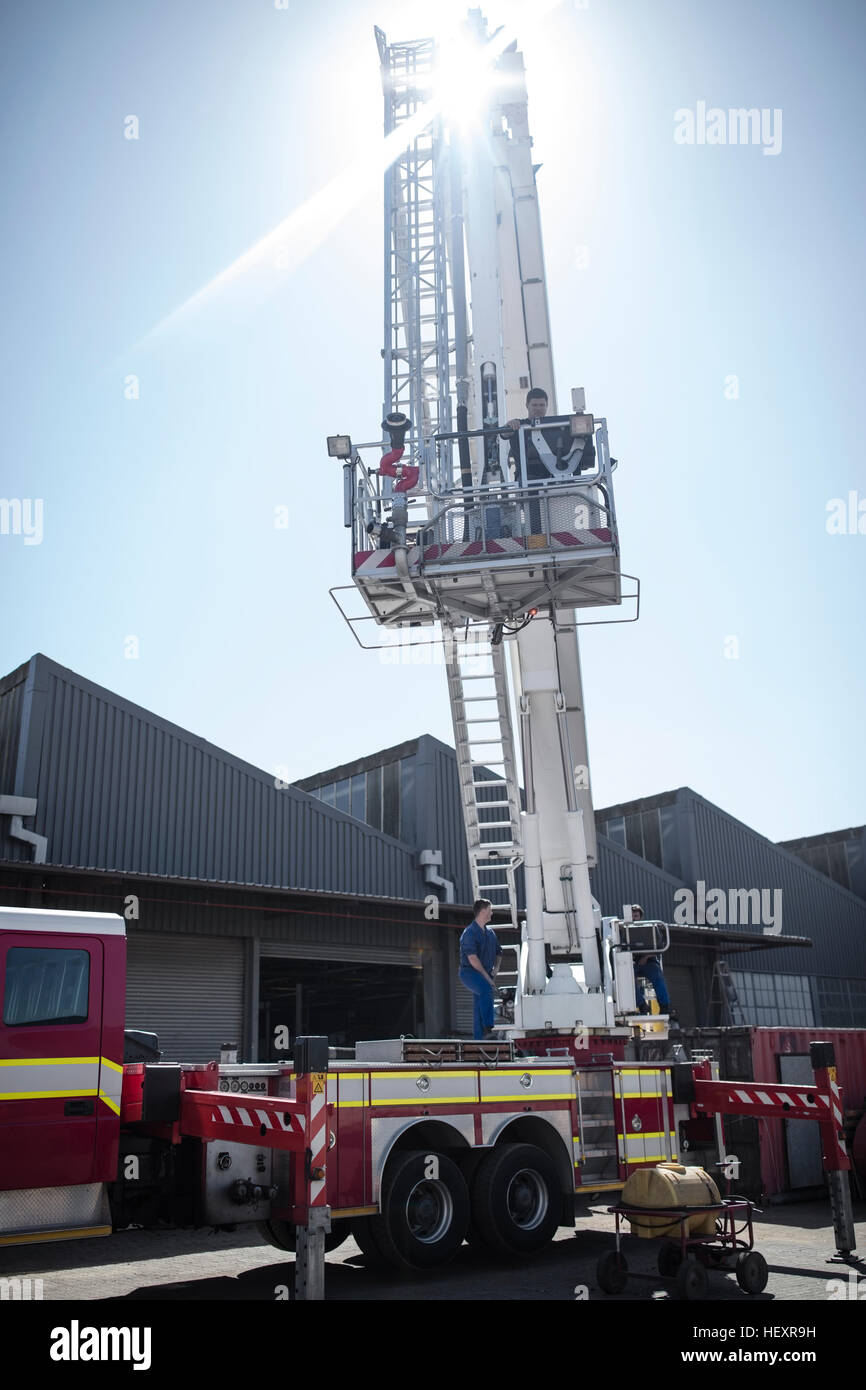Mechanics maintaining fire engine Stock Photo - Alamy