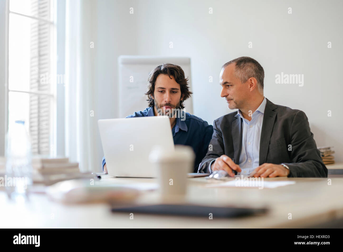 Two businessman working together in office Stock Photo - Alamy