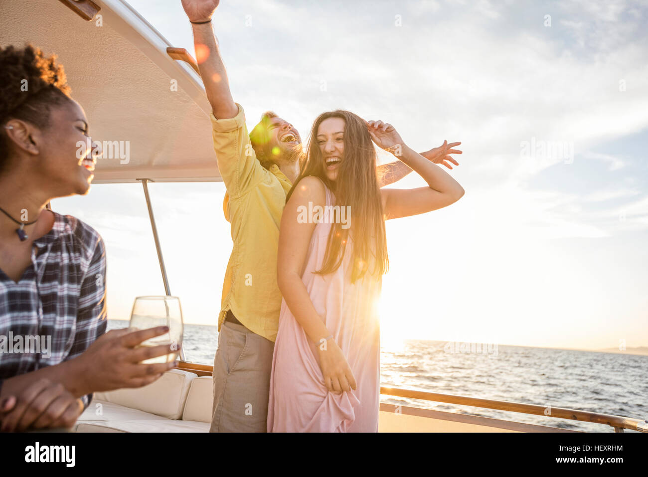 Happy friends having a party on a boat trip Stock Photo - Alamy