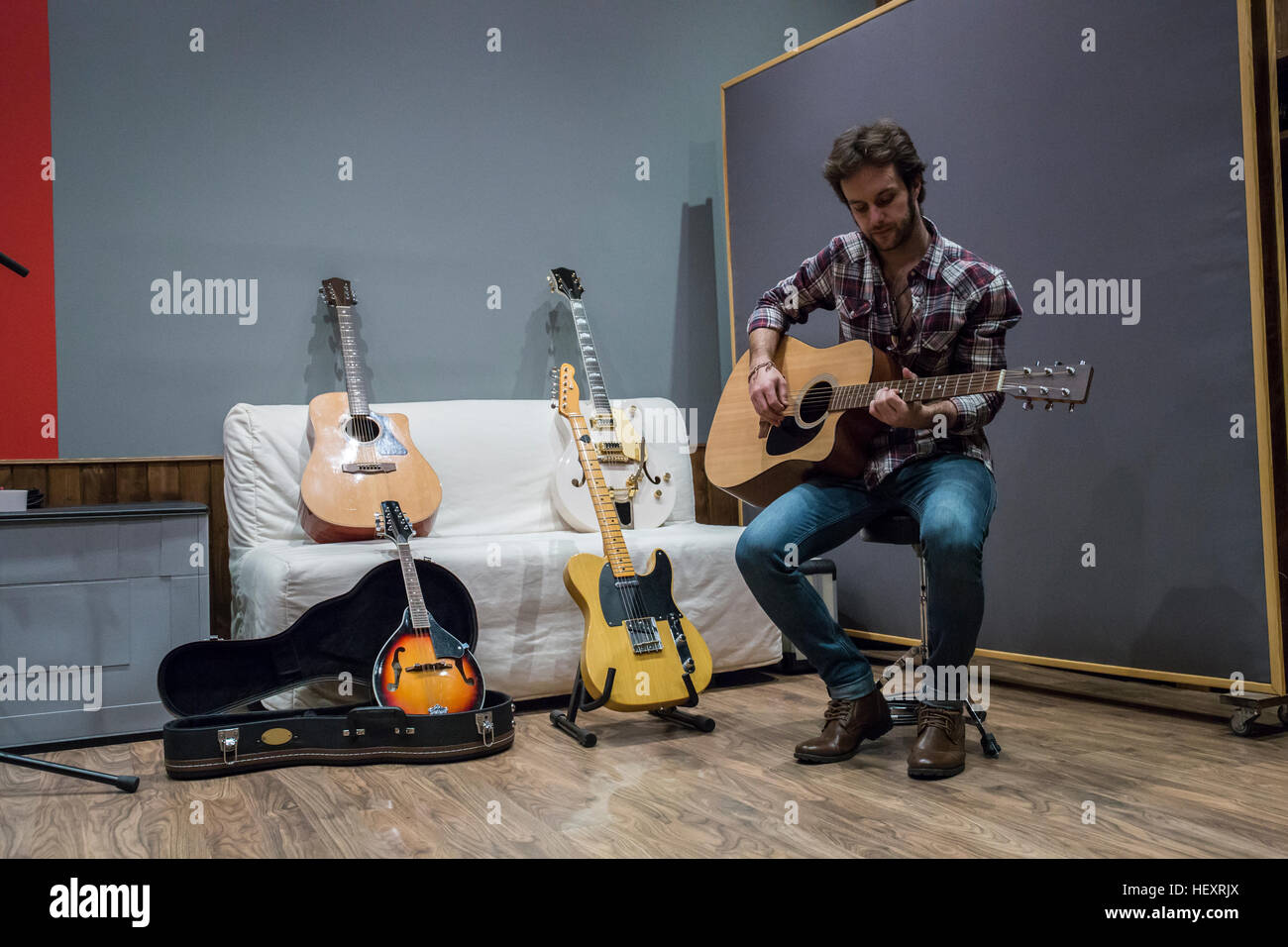 Man playing guitar in a recording studio Stock Photo - Alamy