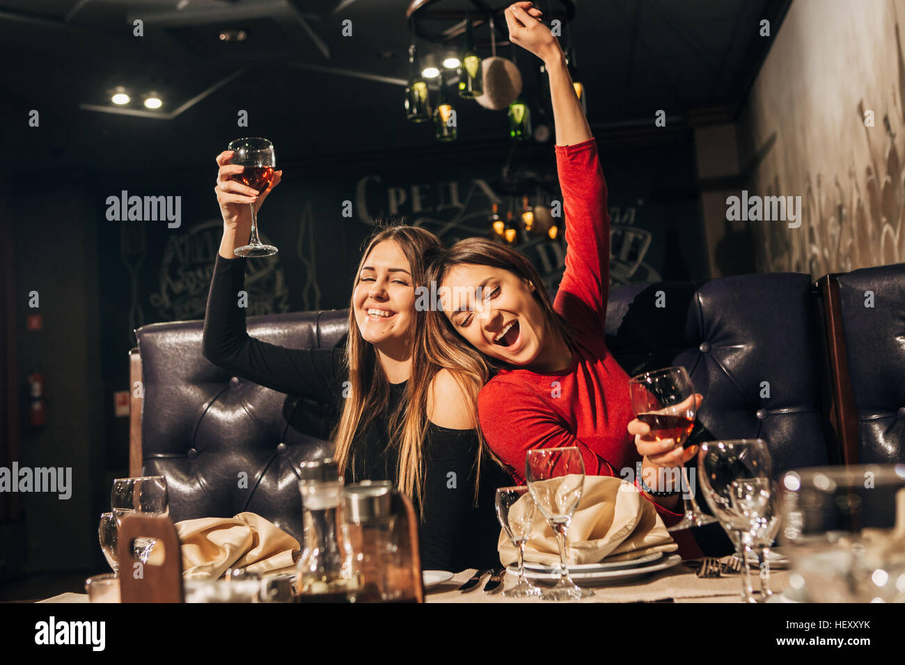 Pretty women talking and having fun inside restaurant Stock Photo - Alamy
