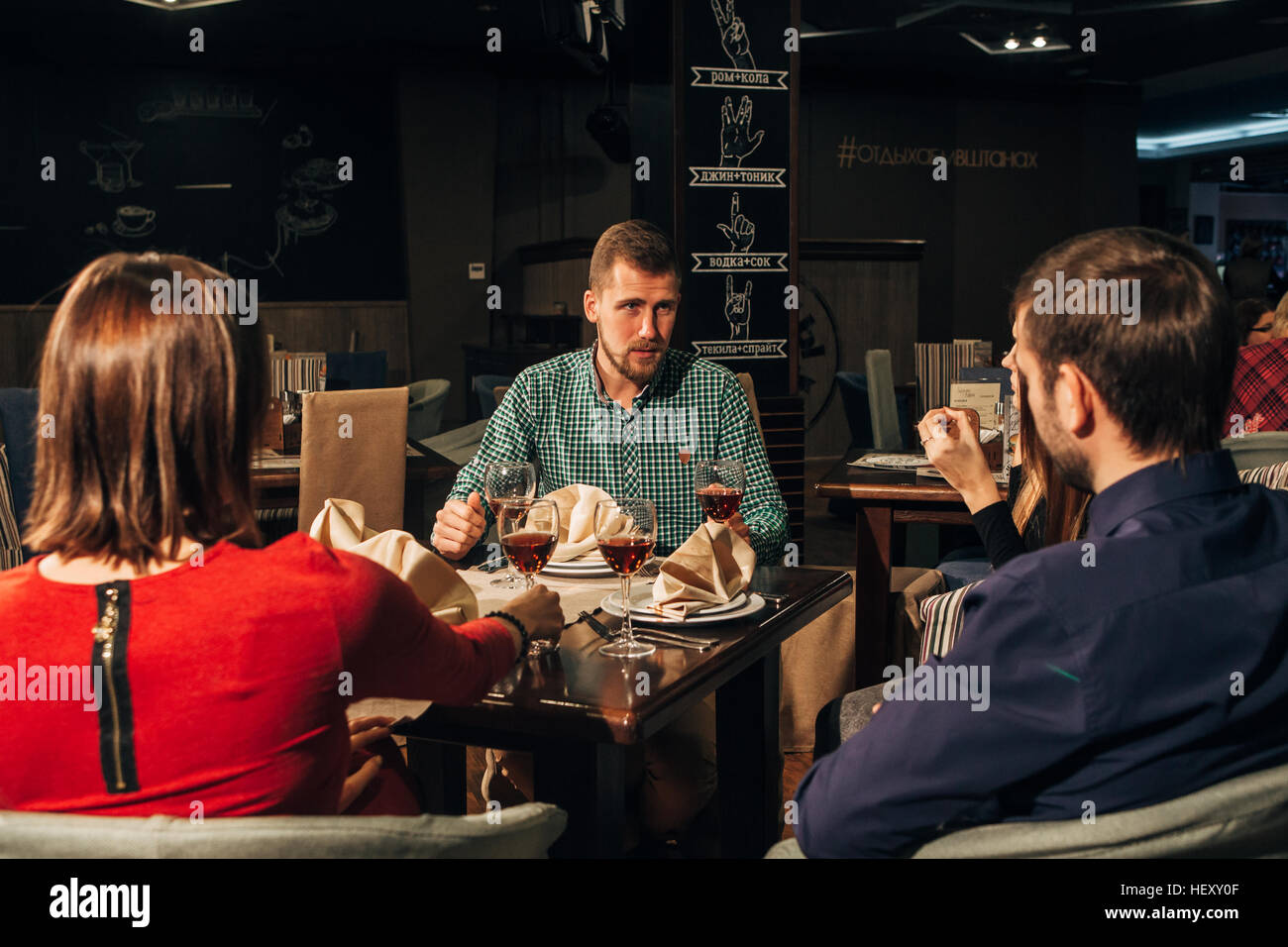 Two Couples Enjoying Meal In Restaurant Together Stock Photo - Alamy