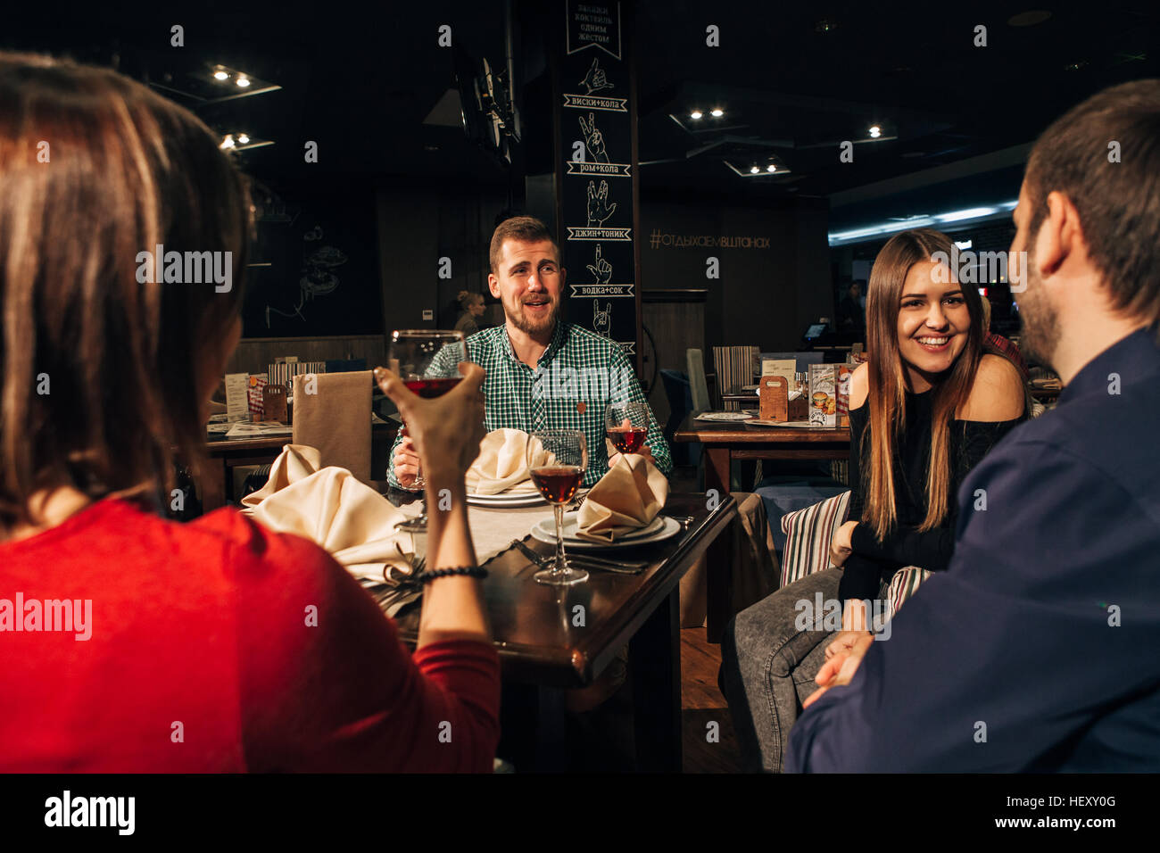 Two Couples Enjoying Meal In Restaurant Together Stock Photo - Alamy