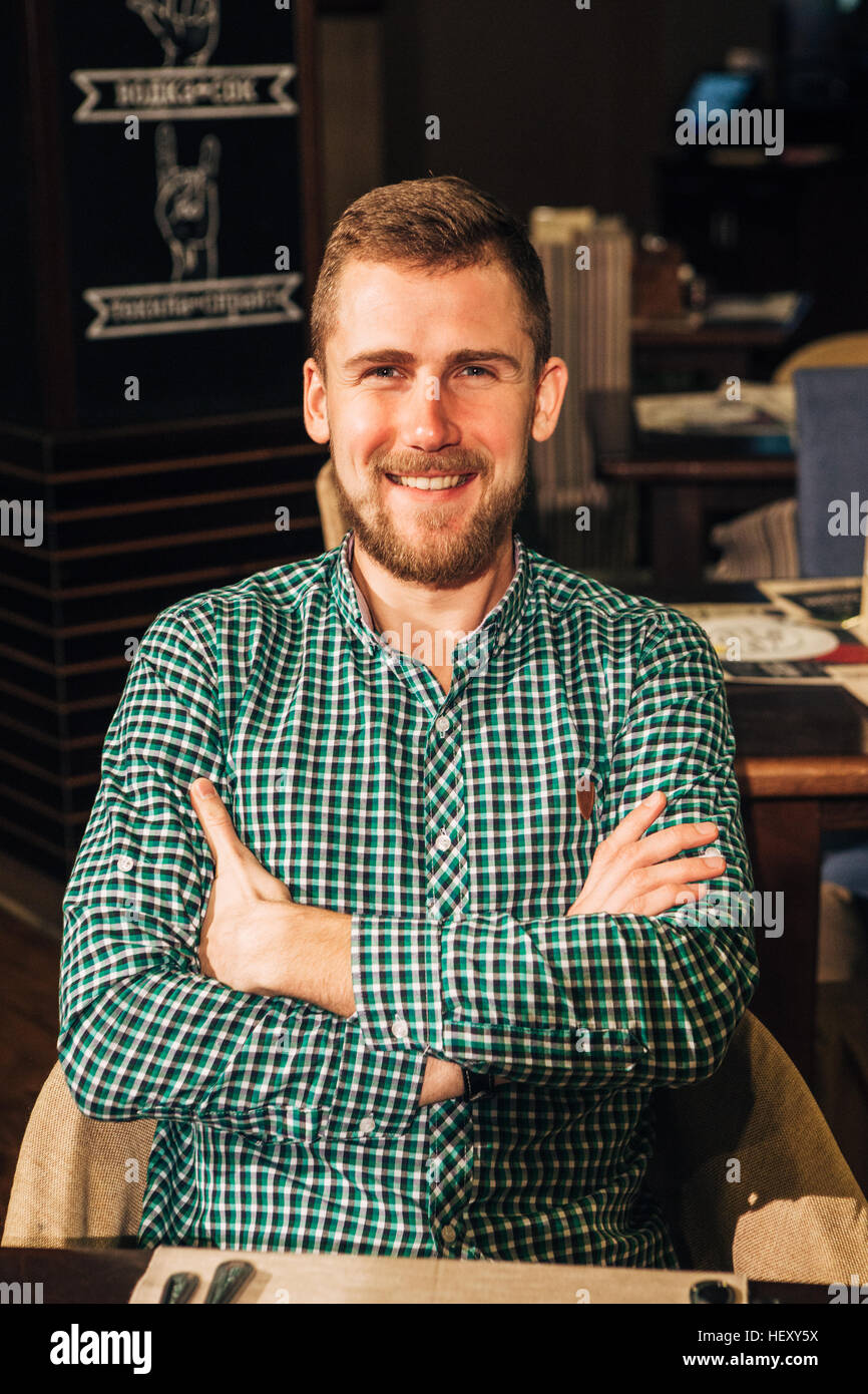 young man in restaurant smiling Stock Photo - Alamy